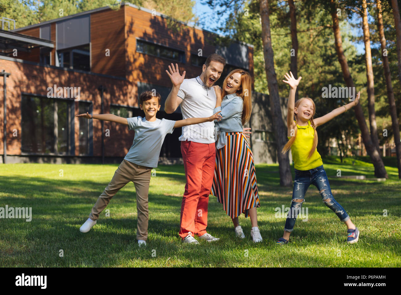 Happy kids having fun with their parents Stock Photo - Alamy