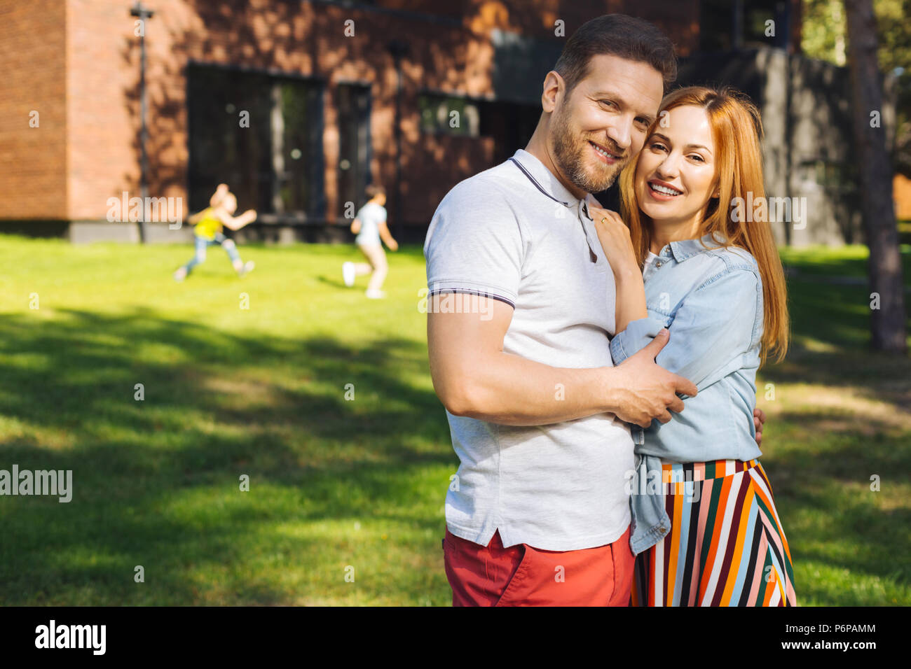 Loving man hugging his wife Stock Photo - Alamy