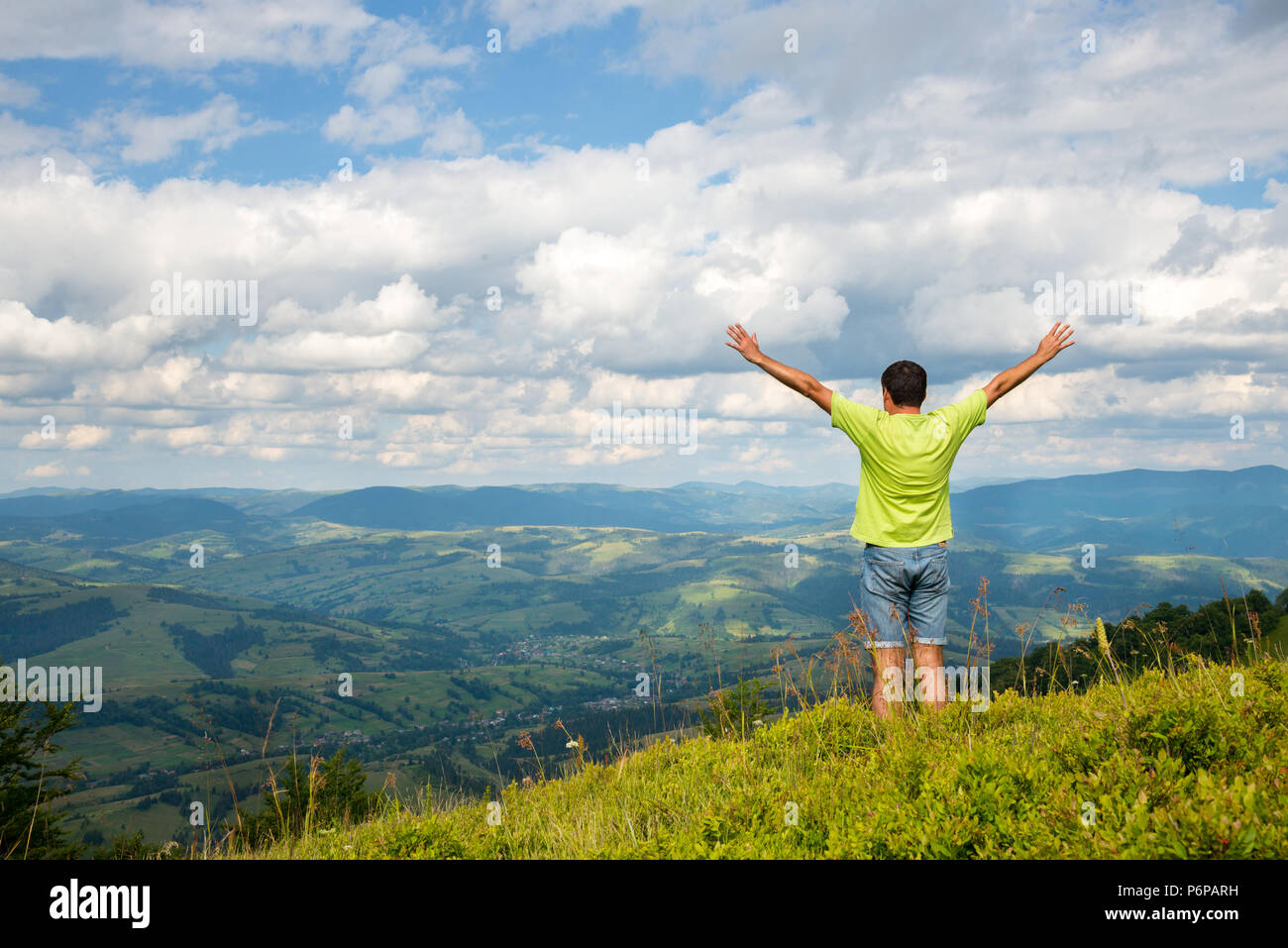 man standing on the top of the mountain. Cloudy Stock Photo - Alamy