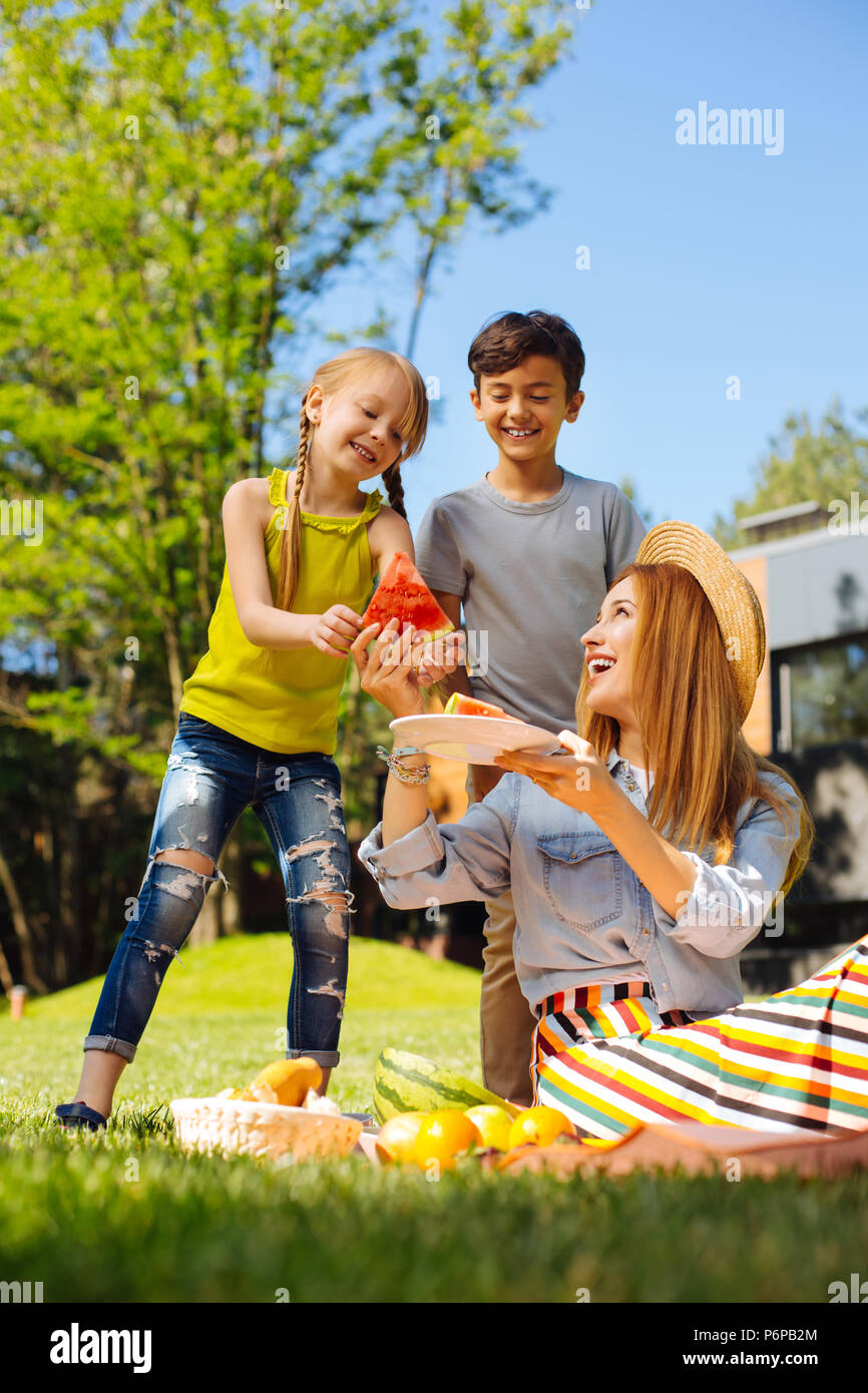 Exuberant mother having a picnic with her family Stock Photo - Alamy