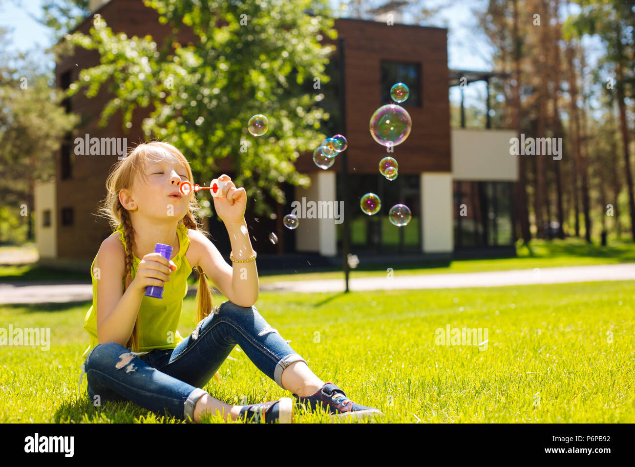 Alert girl blowing soap bubbles Stock Photo - Alamy