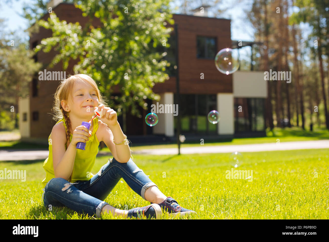 Cheerful girl blowing soap bubbles Stock Photo - Alamy