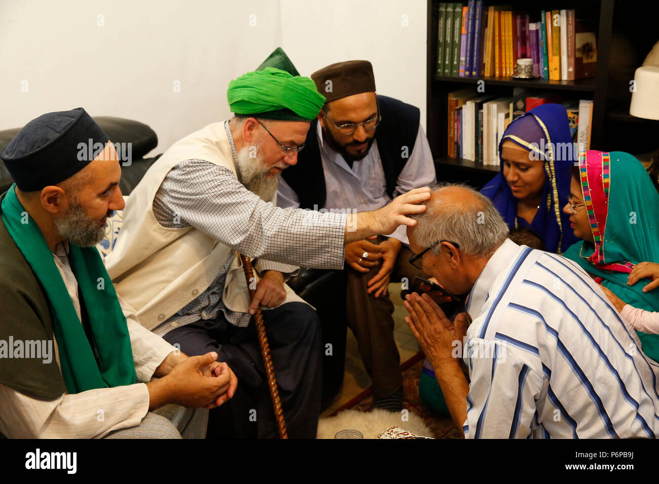 Sufi muslim receiving a blessing from Mawlana Sheikh Mehmet Efendi in ...