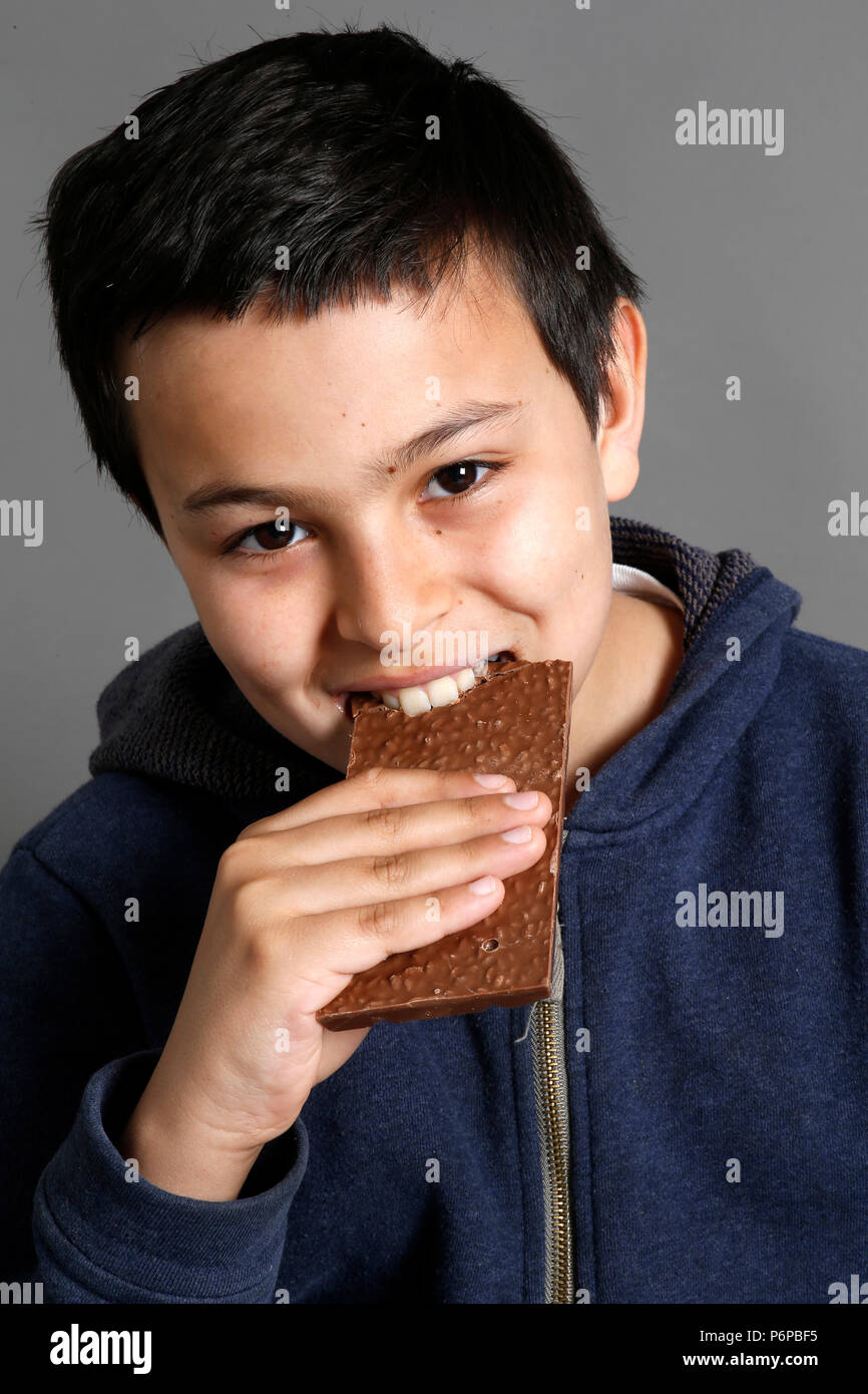 Teenager eating chocolate hi-res stock photography and images - Alamy
