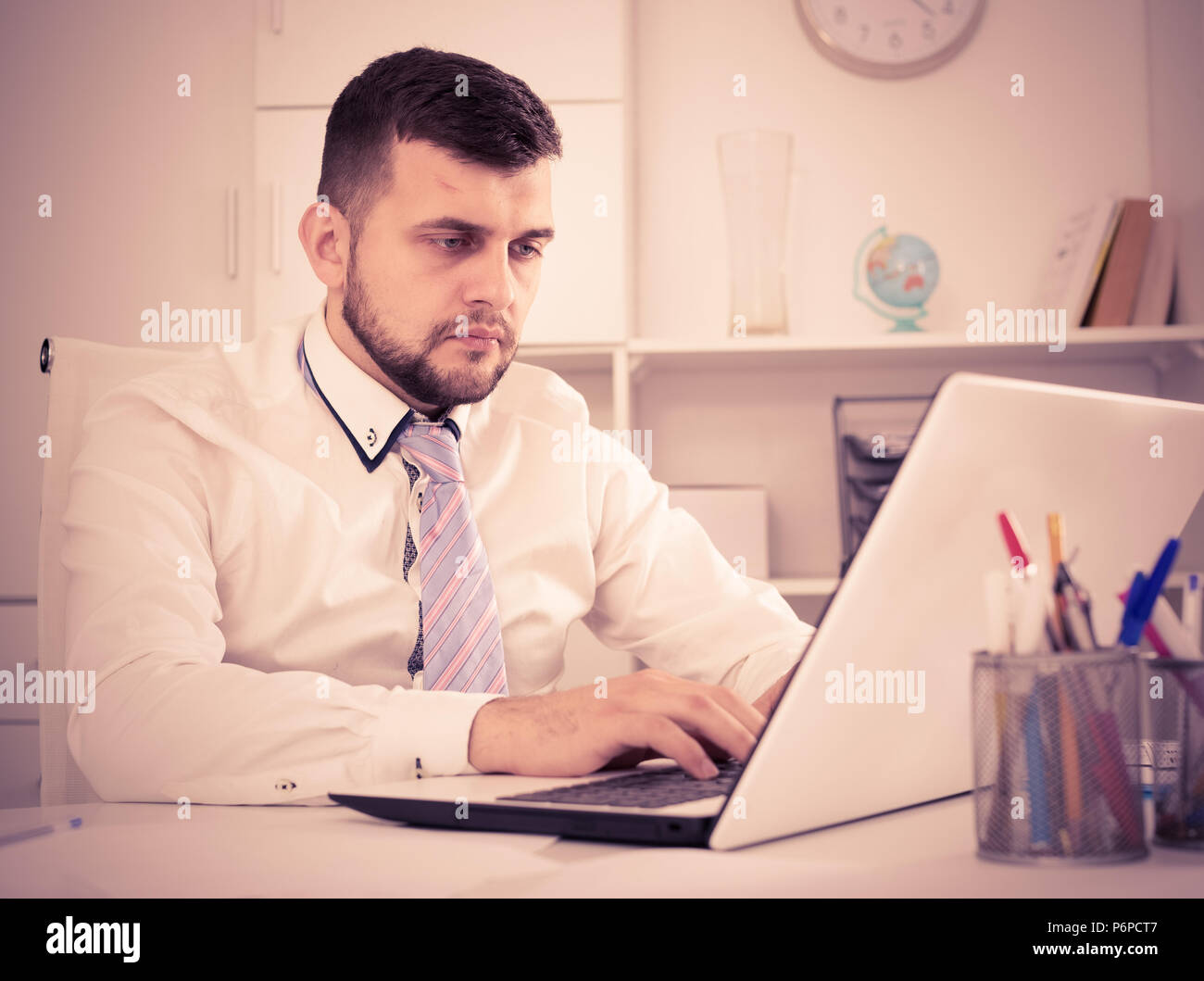 Smiling man worker working effectively on project in office Stock Photo ...