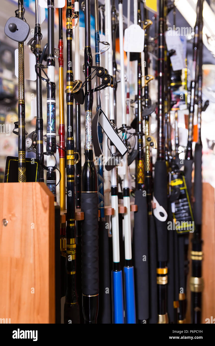 stand with colorful fishing rods in the sports shop indoor Stock Photo ...