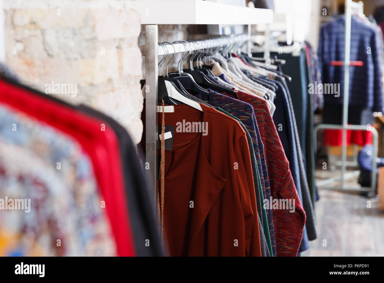 Different assortment of colorful clothing in the modern showroom Stock ...