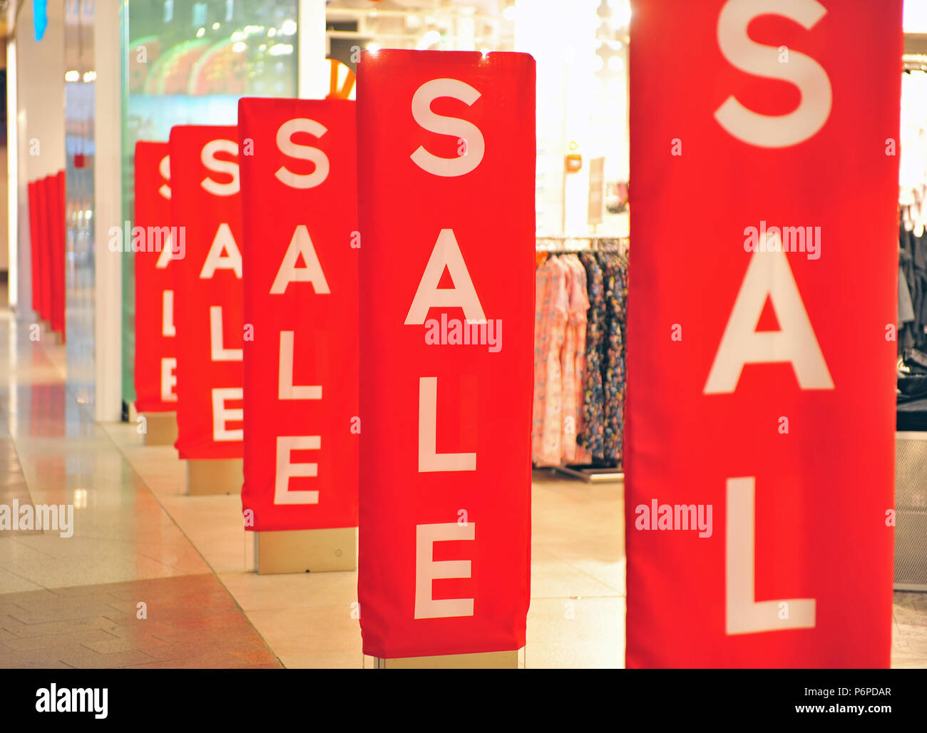 Sale red signs at retail store Stock Photo - Alamy
