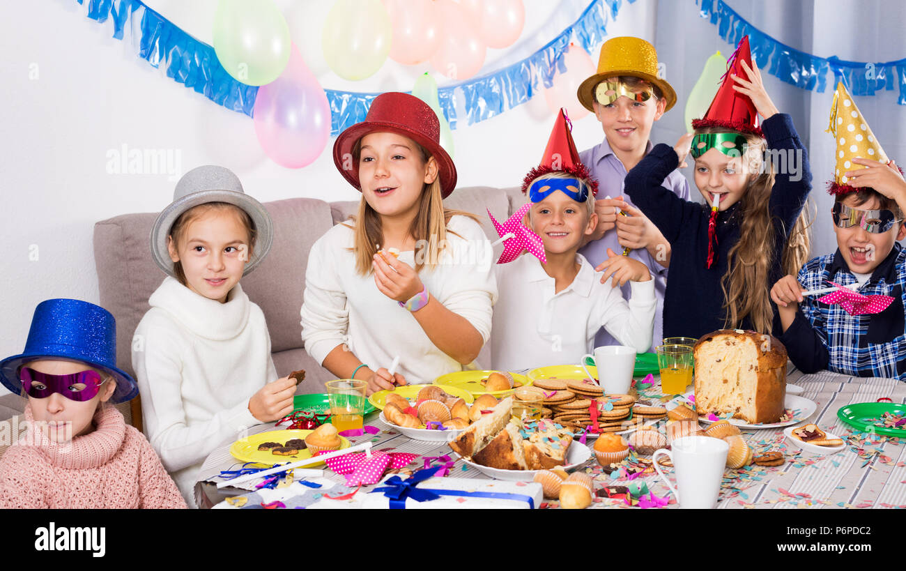 Glad children having fun during friend’s birthday party at his home ...