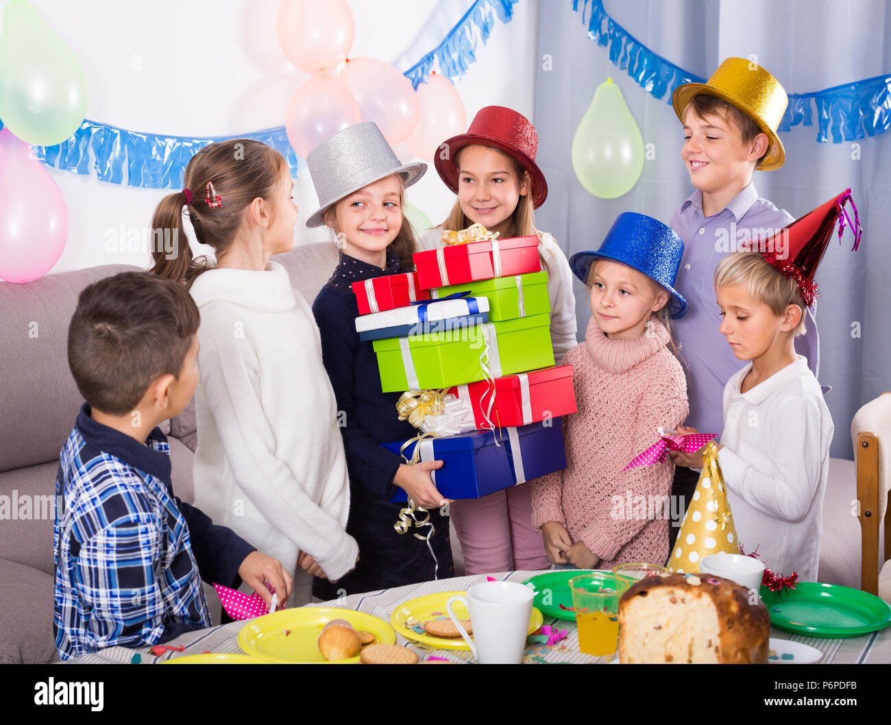 positive children giving presents to little girl during party Stock ...
