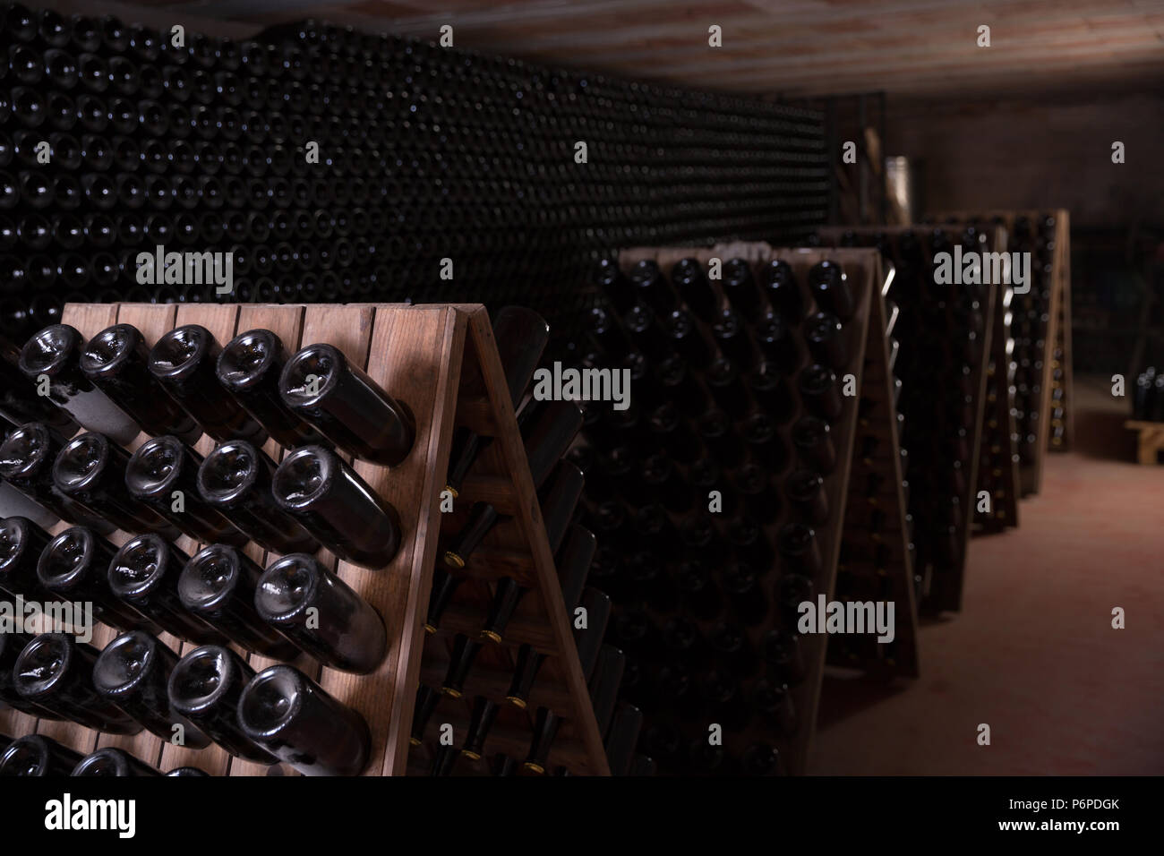 Process of wine maturation in bottles on wooden racks in wine vault ...