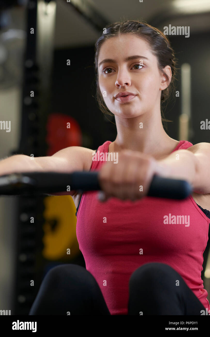 Young Woman In Gym Exercising On Rowing Machine Stock Photo - Alamy