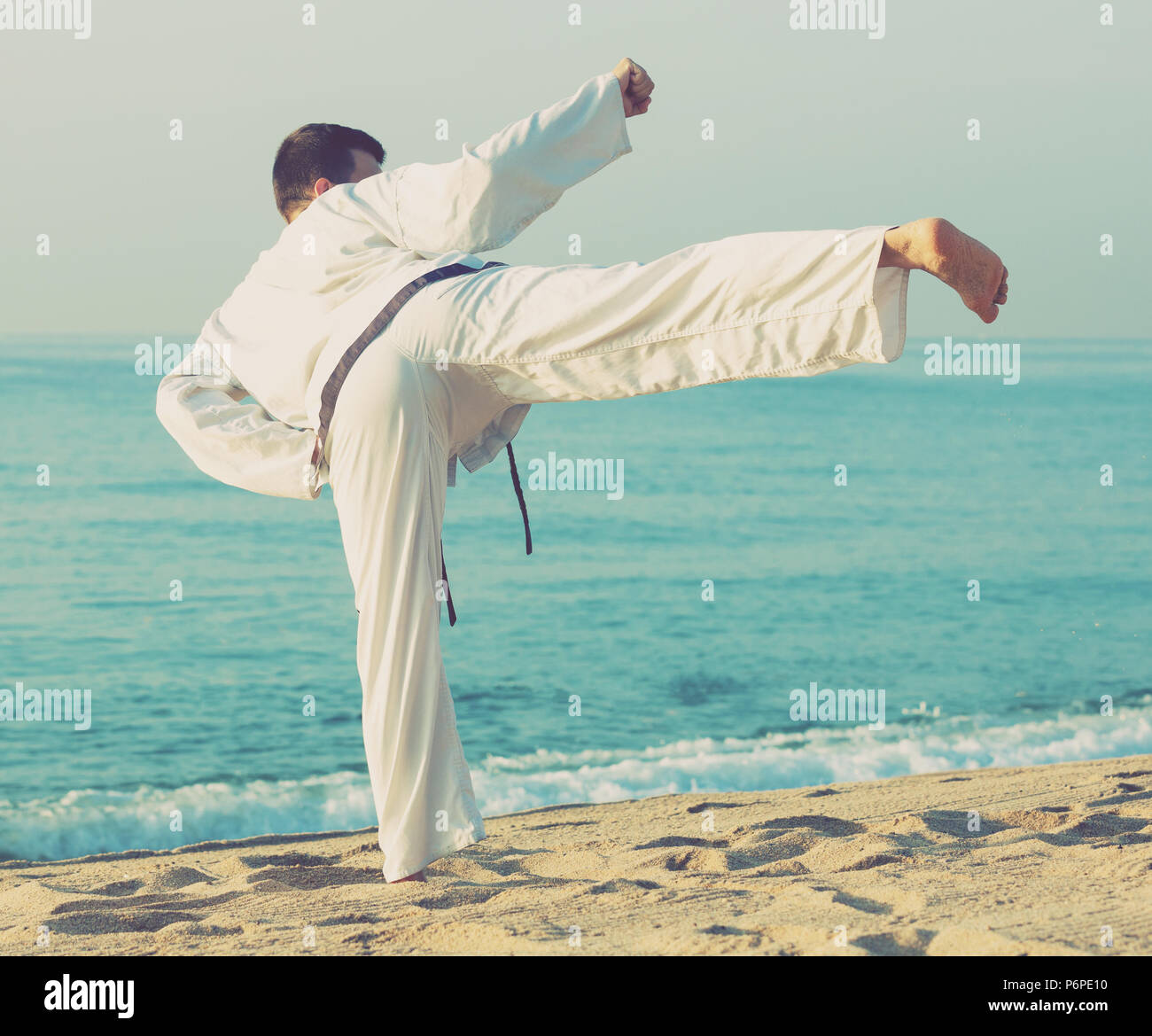 Young guy training karate poses at beach in sunny morning outdoor Stock ...