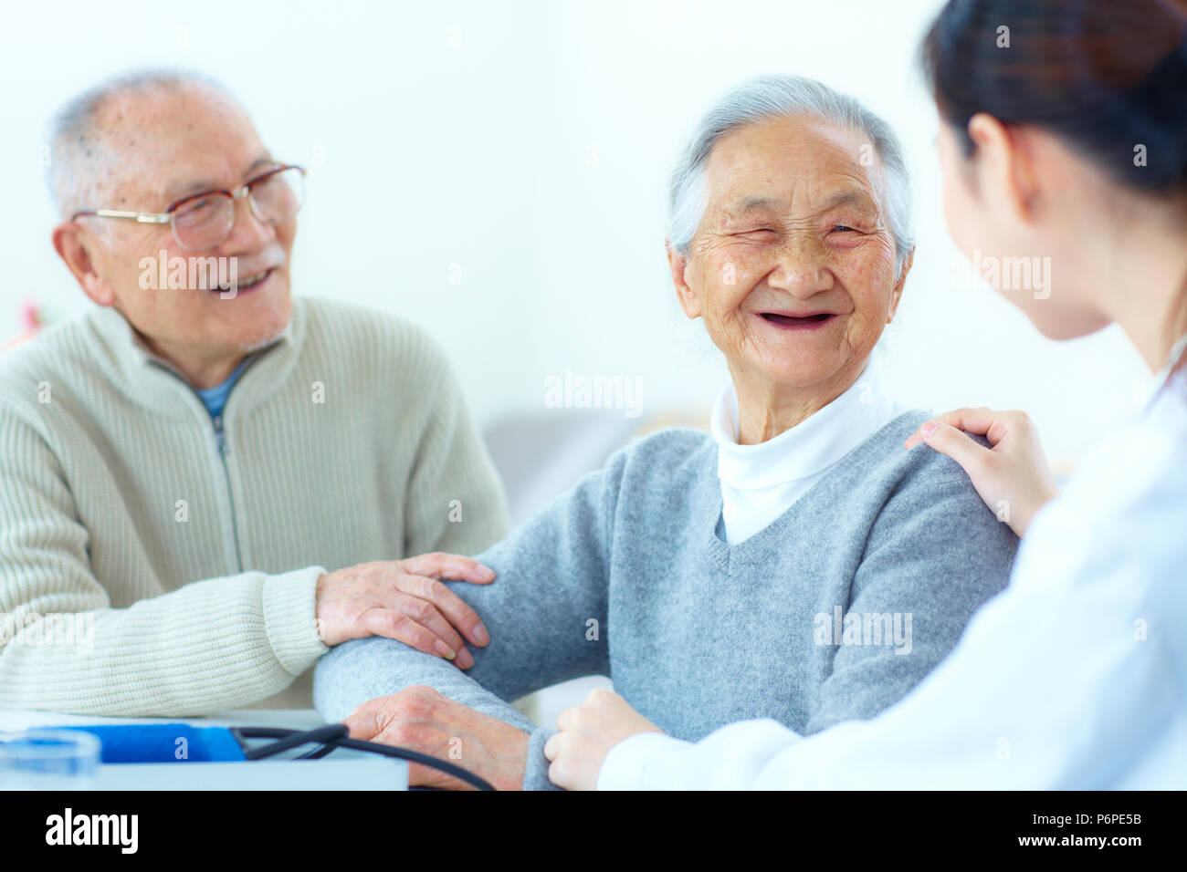 one young asian female doctor doing health check to senior Chinese ...