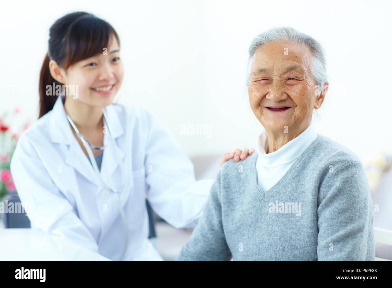 one young asian female doctor doing health check to senior Chinese ...
