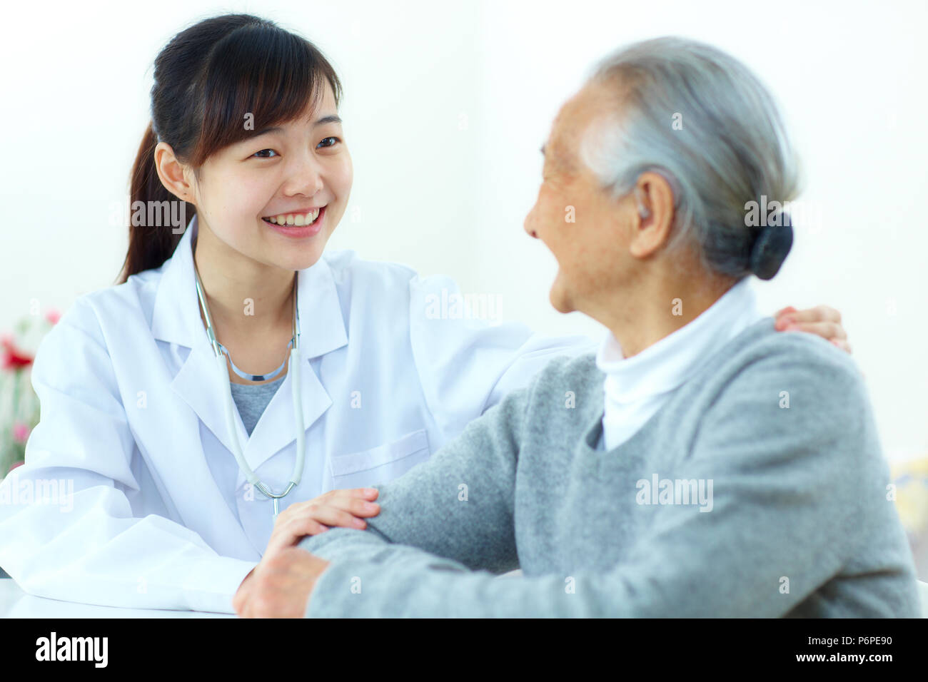 one young asian female doctor doing health check to senior Chinese ...