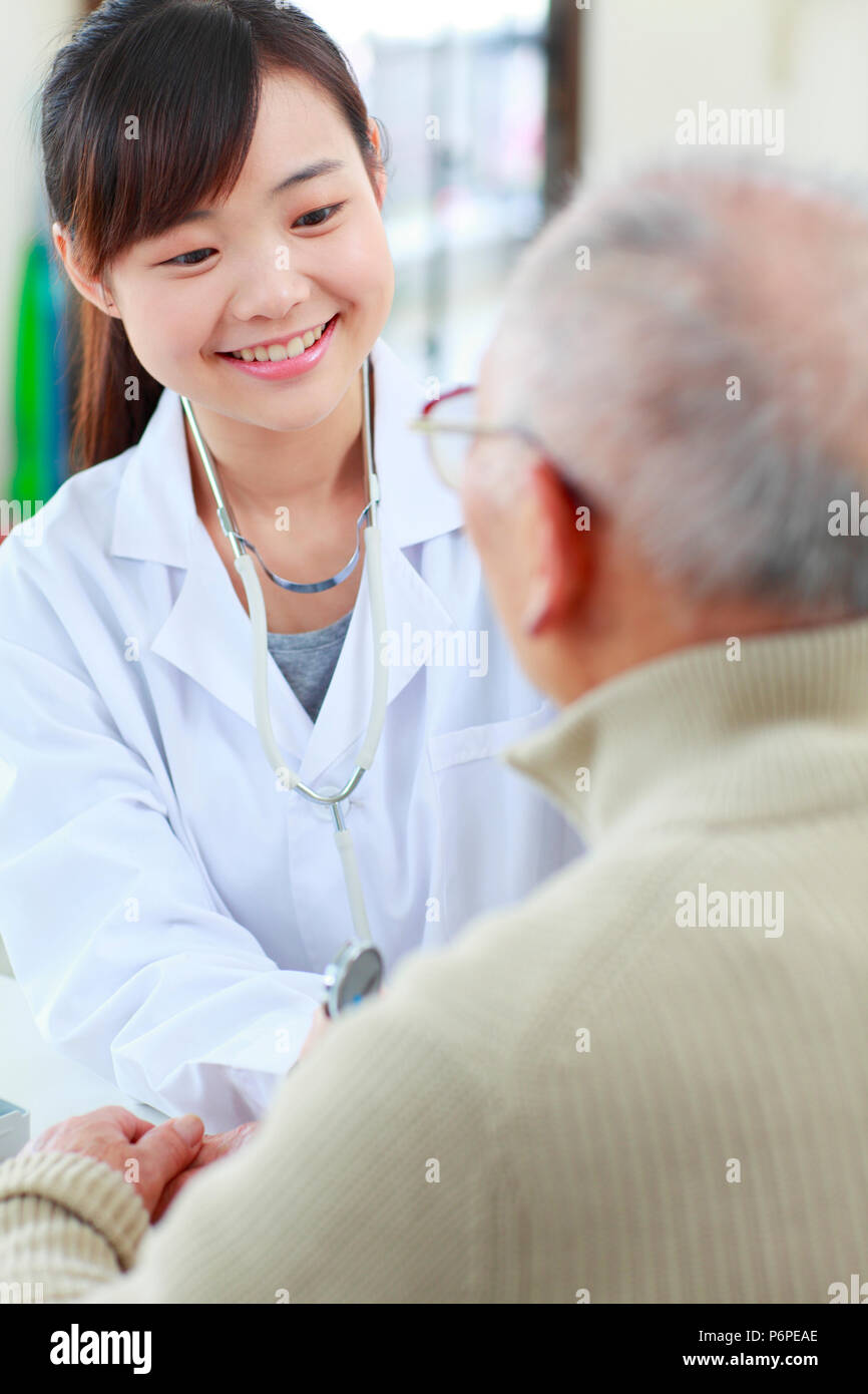 young asian female doctor doing medical healthy check to senior Chinese ...