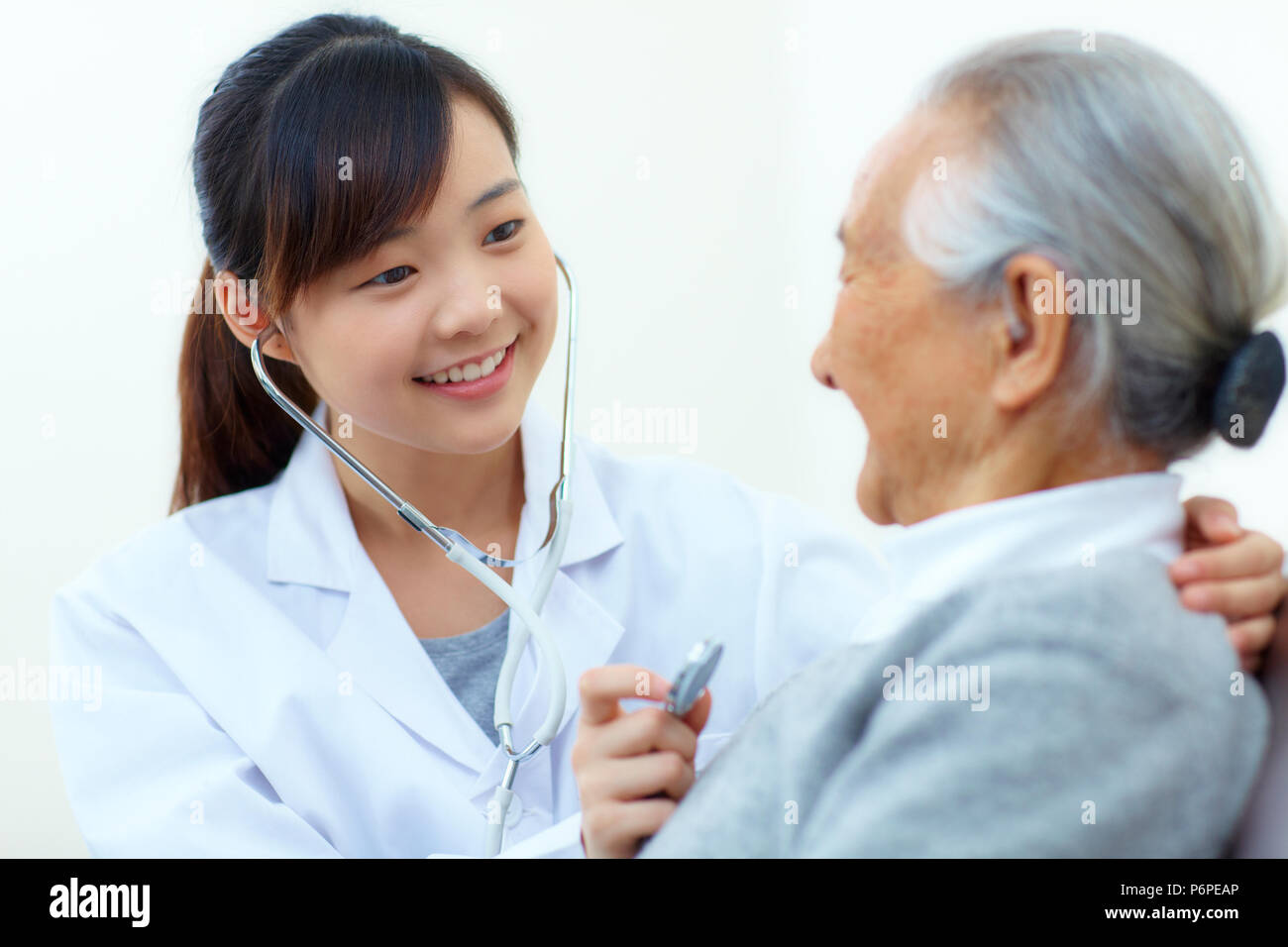 one young asian female doctor doing health check to senior Chinese ...