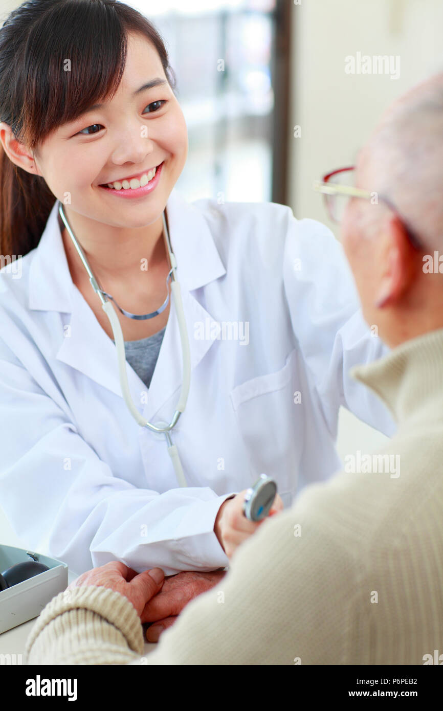 young asian female doctor doing medical healthy check to senior Chinese ...