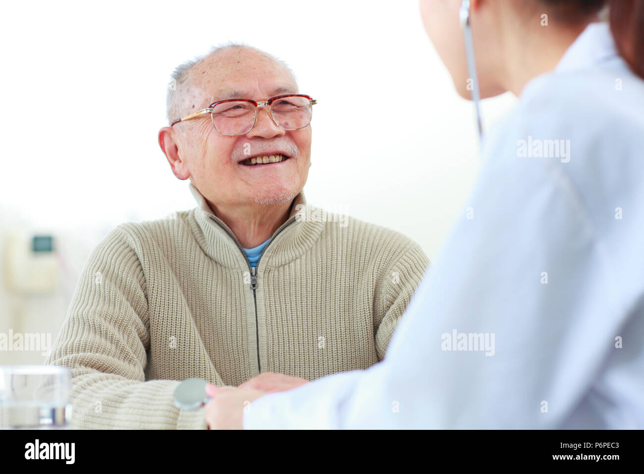 young asian female doctor doing medical healthy check to senior Chinese ...