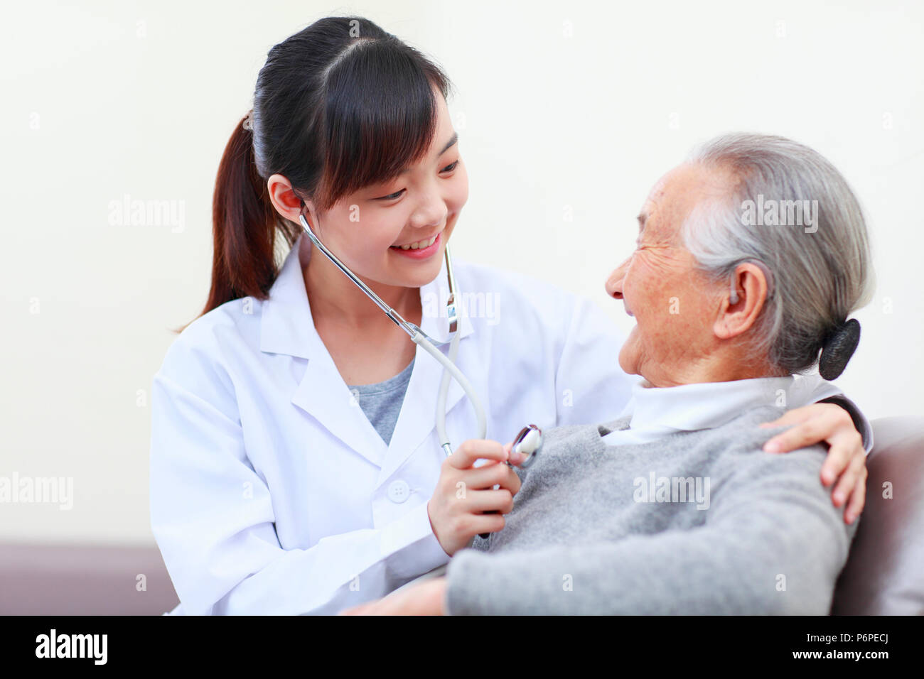 one young asian female doctor doing health check to senior Chinese ...