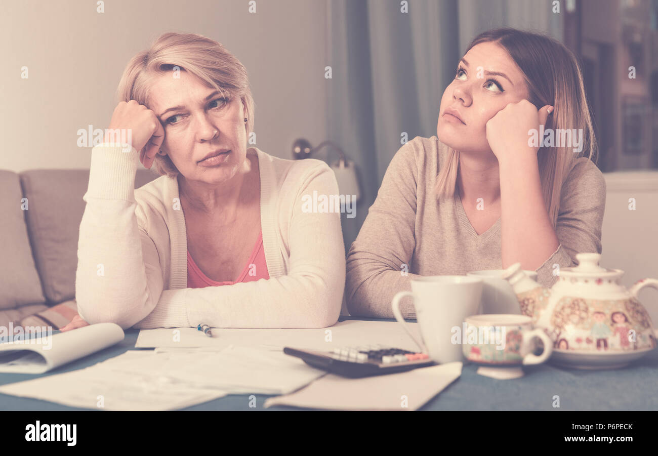 Sad mother and her adult daughter with big financial problems are ...