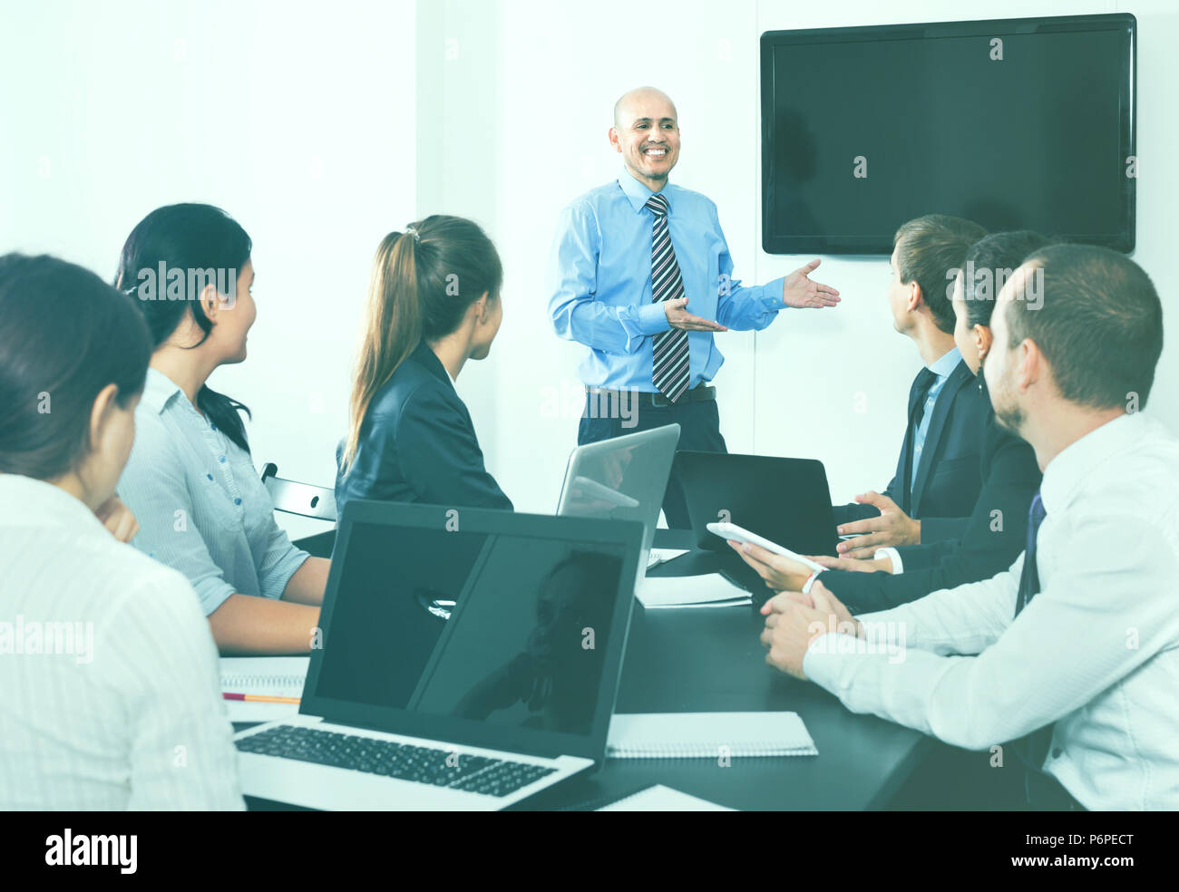 Manager making speech during business meeting in office Stock Photo - Alamy