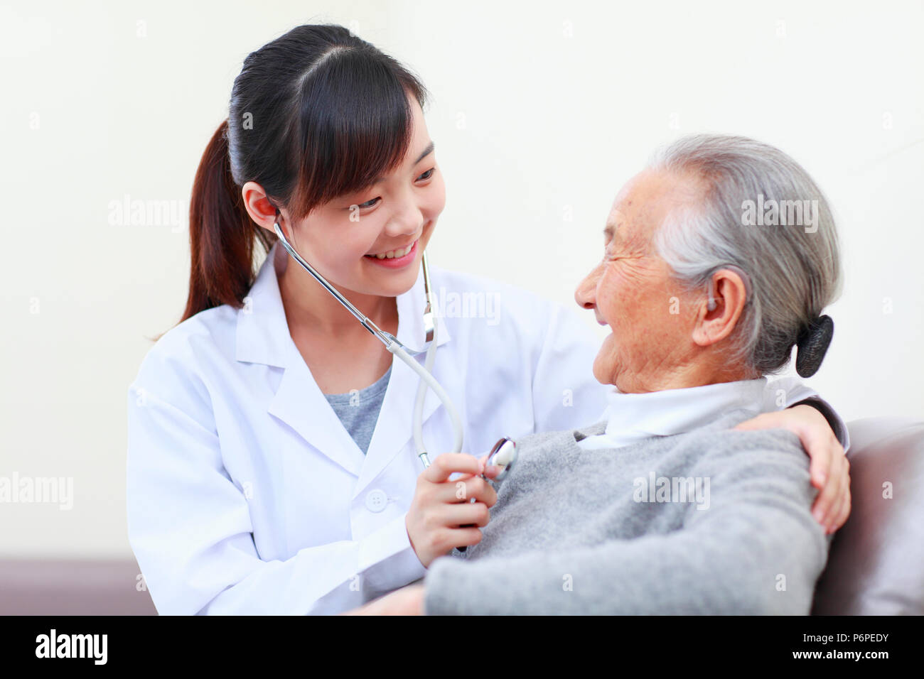 one young asian female doctor doing health check to senior Chinese ...