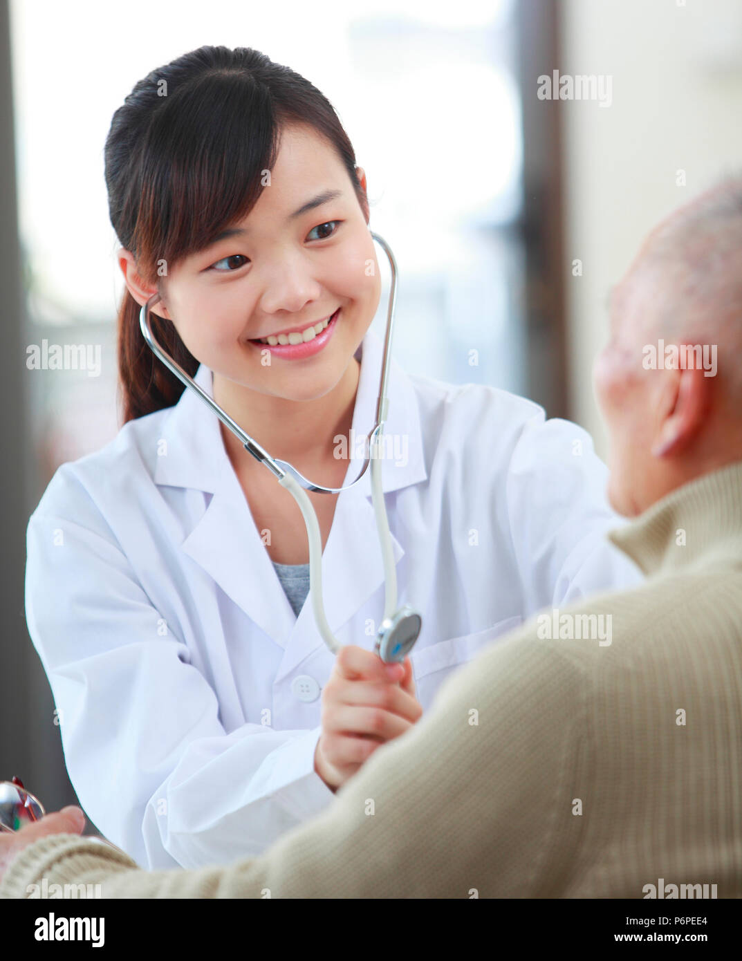 young asian female doctor doing medical healthy check to senior Chinese ...