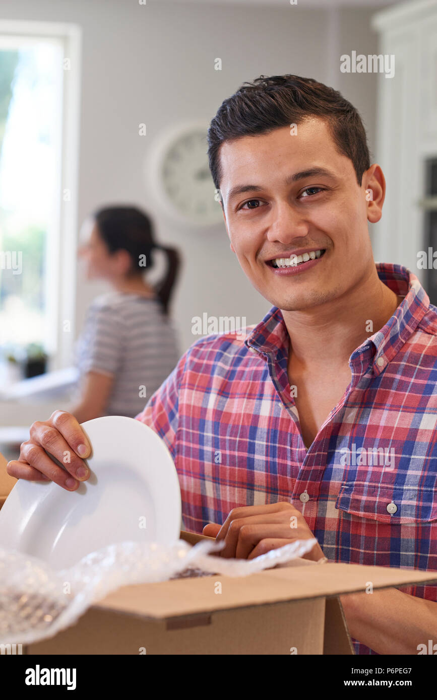 Portrait Of Young Couple Unpacking Boxes In Kitchen On Moving Day Stock ...