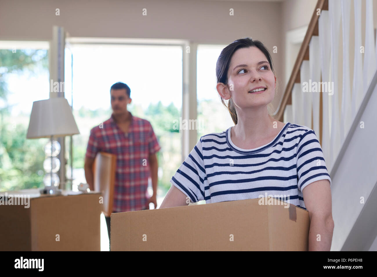 Couple Carrying Boxes Into New Home On Moving Day Stock Photo - Alamy