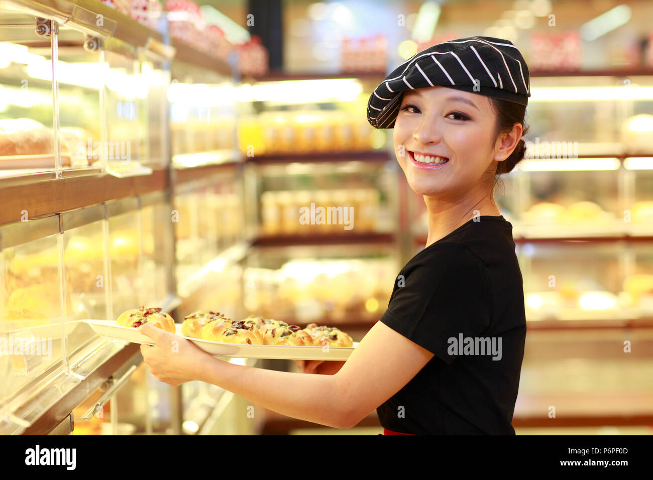 female baker in bakery working Stock Photo - Alamy