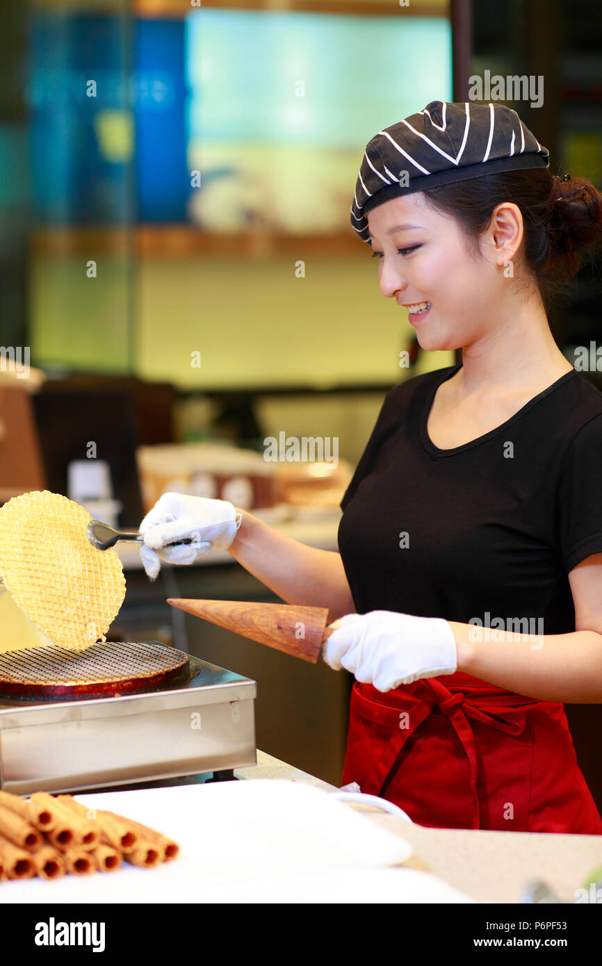 female baker in bakery working Stock Photo - Alamy