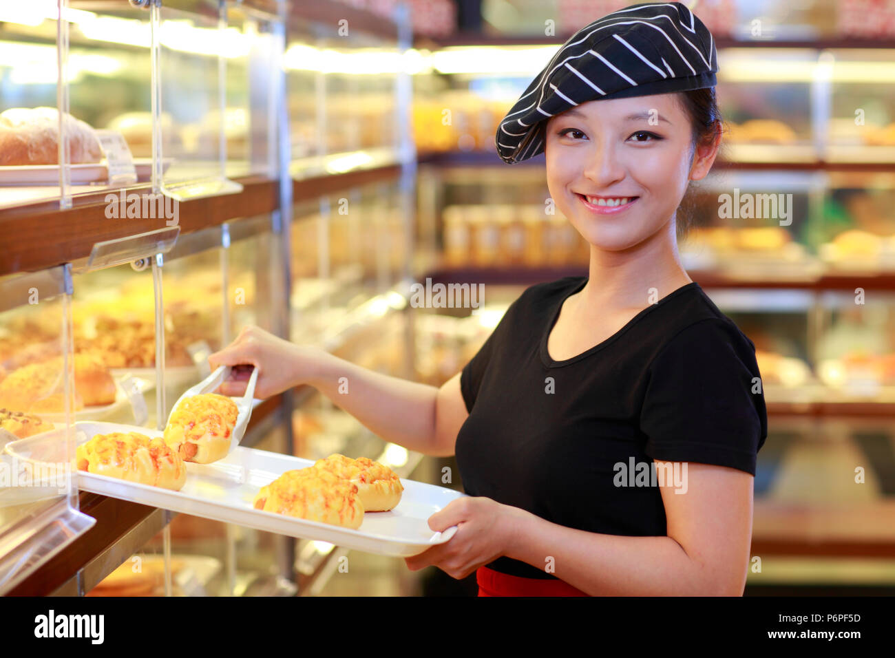 female baker in bakery working Stock Photo - Alamy