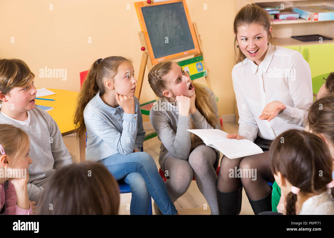 Young female teacher caused surprise of children with story at lesson ...