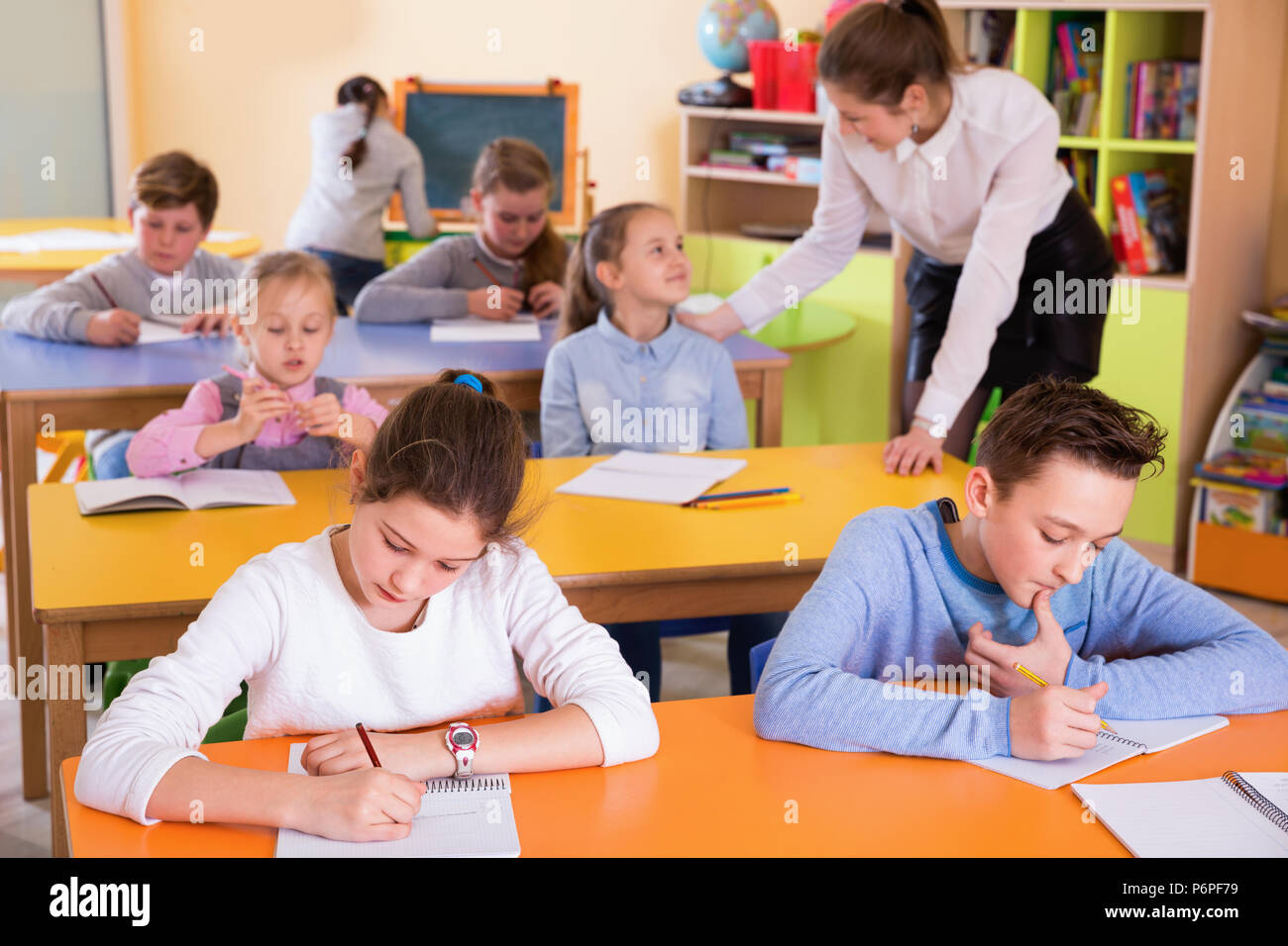 Portrait of friendly smiling pleasant teacher woman at lesson with ...