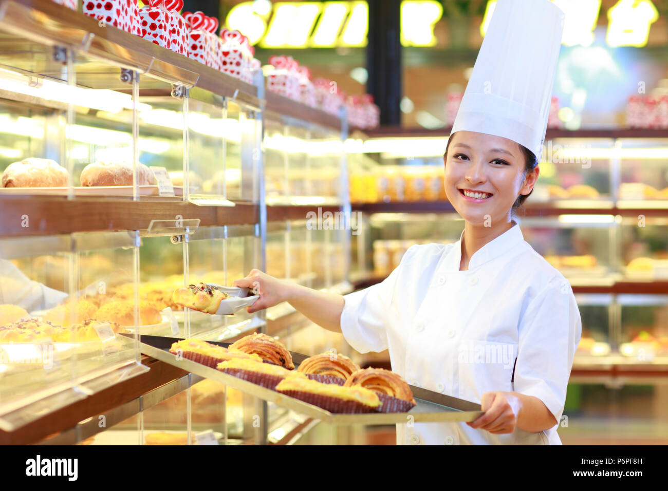 female baker in bakery working Stock Photo - Alamy
