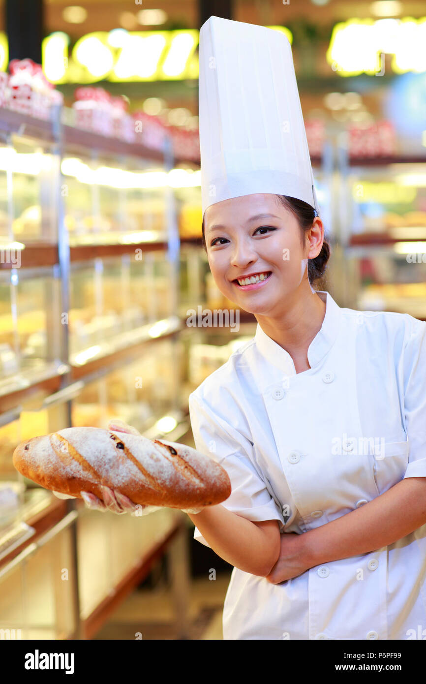 female baker in bakery working Stock Photo - Alamy