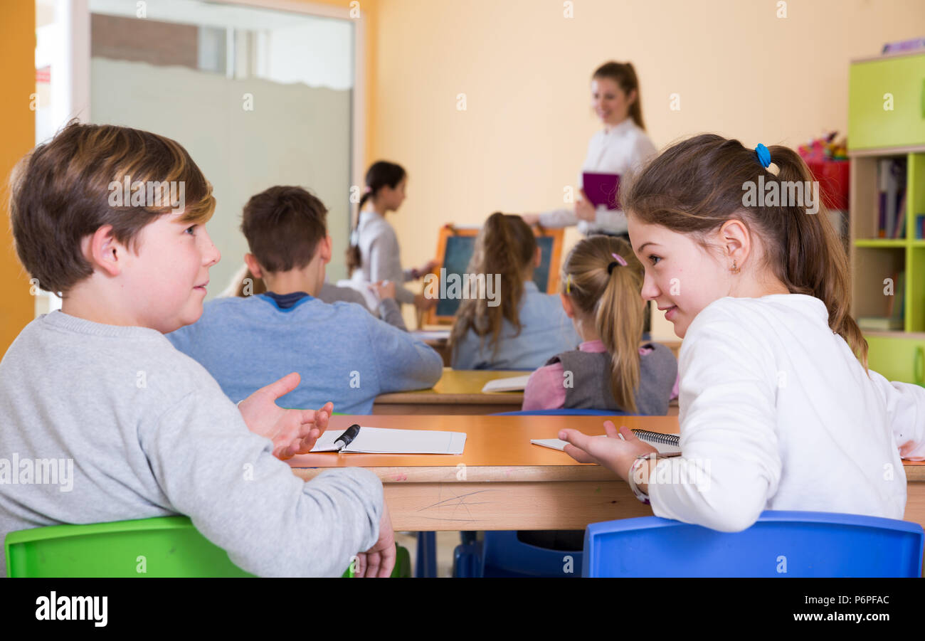 Portrait of children discussing something during lesson in school Stock ...