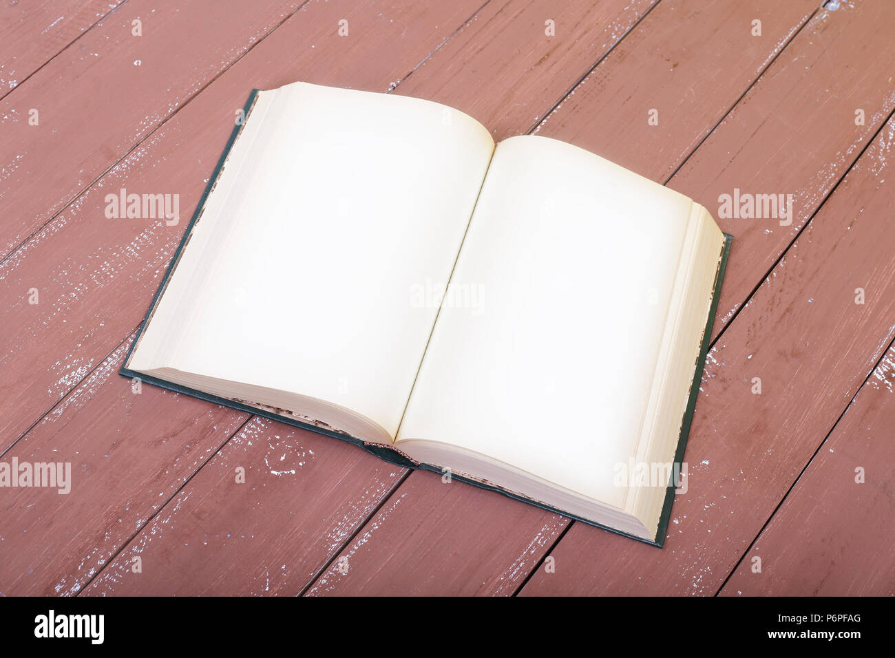 Science and education - Old empty open book top view on a wooden table ...