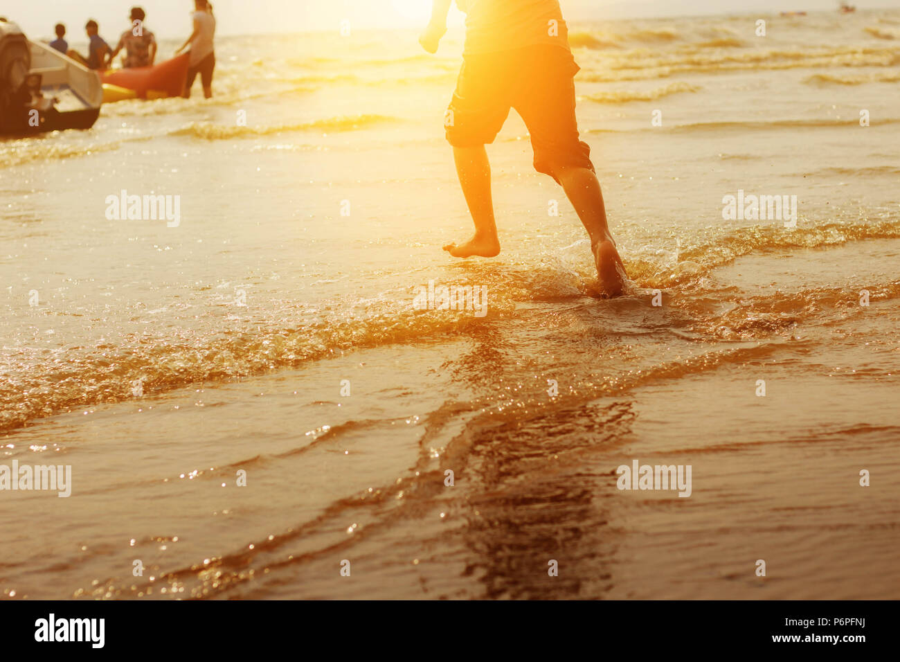 Boy running down the beach hi-res stock photography and images - Alamy