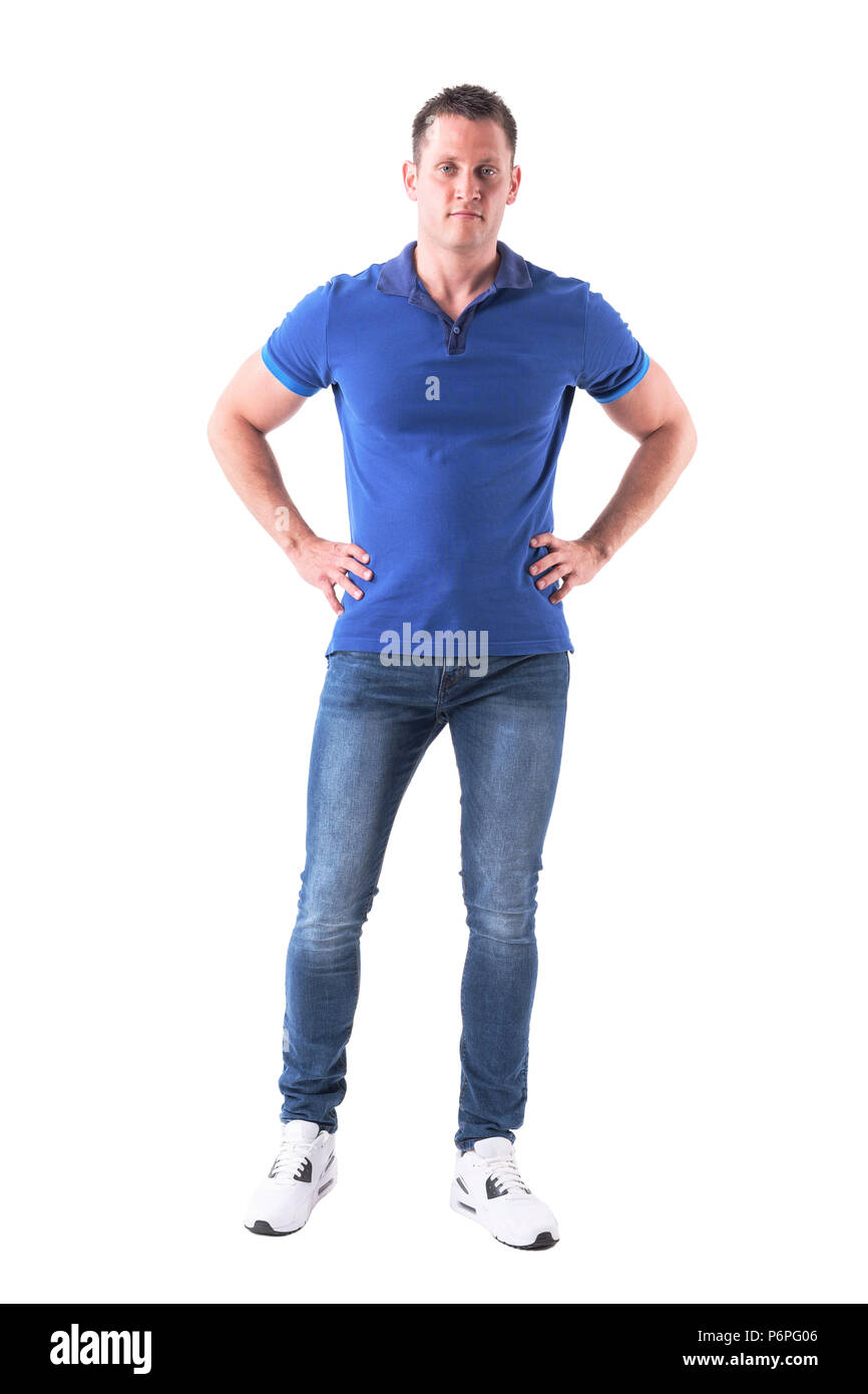Serious confident fit man in casual clothes with hands on hips looking ...