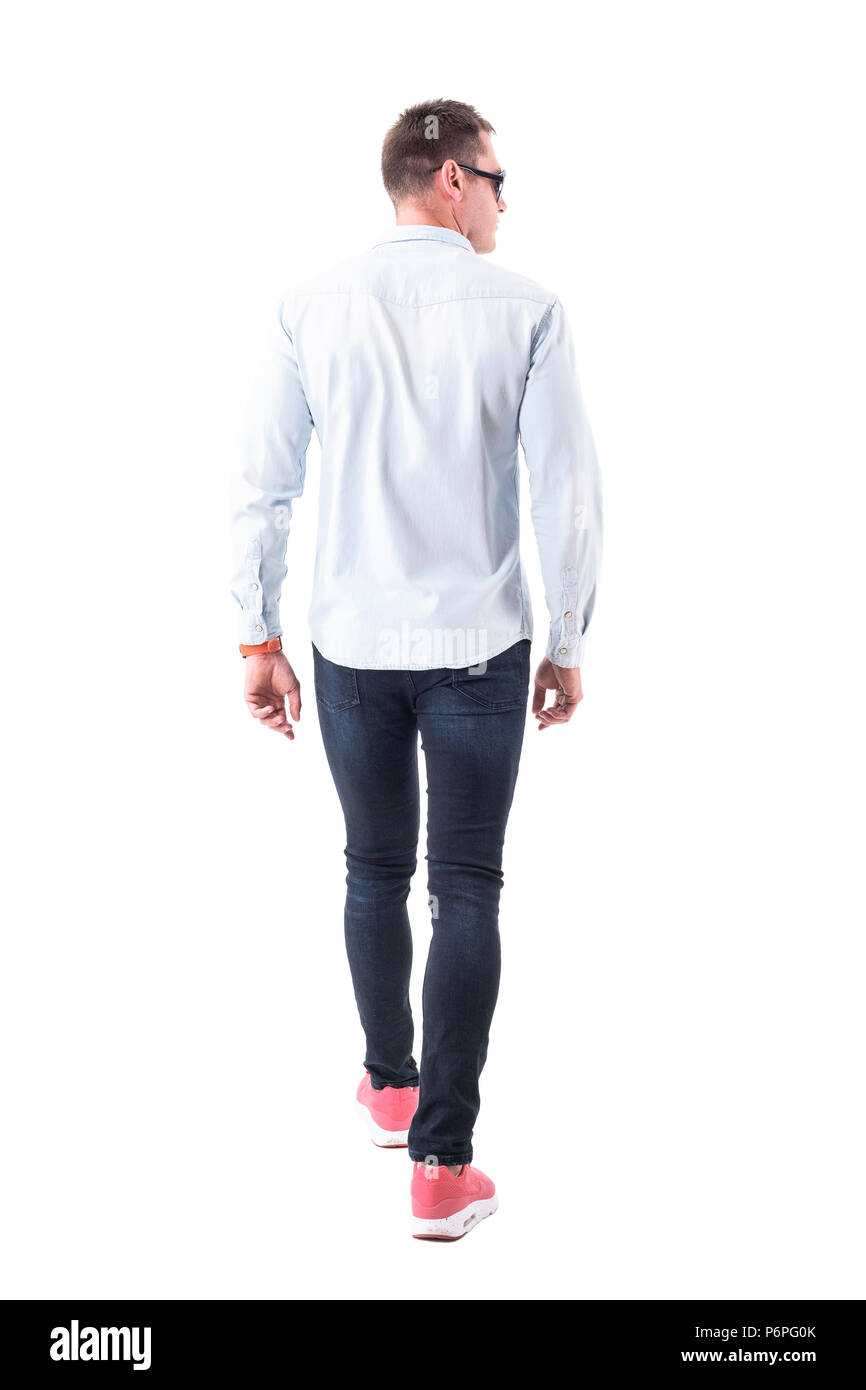 Rear view of elegant handsome man fashion model with sunglasses walking ...