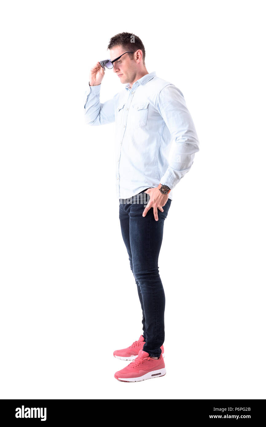 Side view of elegant handsome business man taking off sunglasses and ...