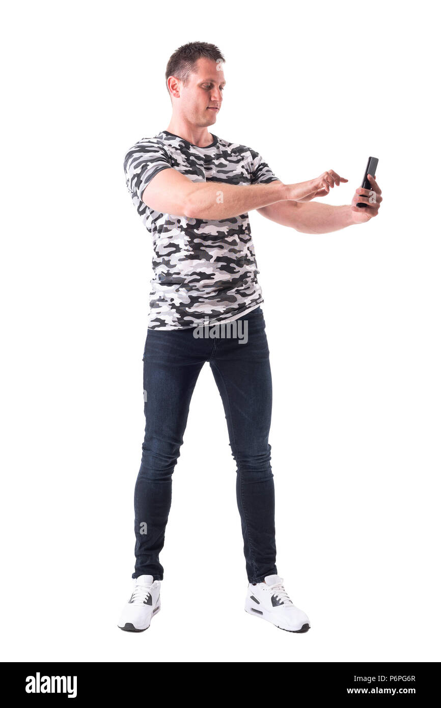 Handsome young adult man holding mobile phone and pushing touch screen ...