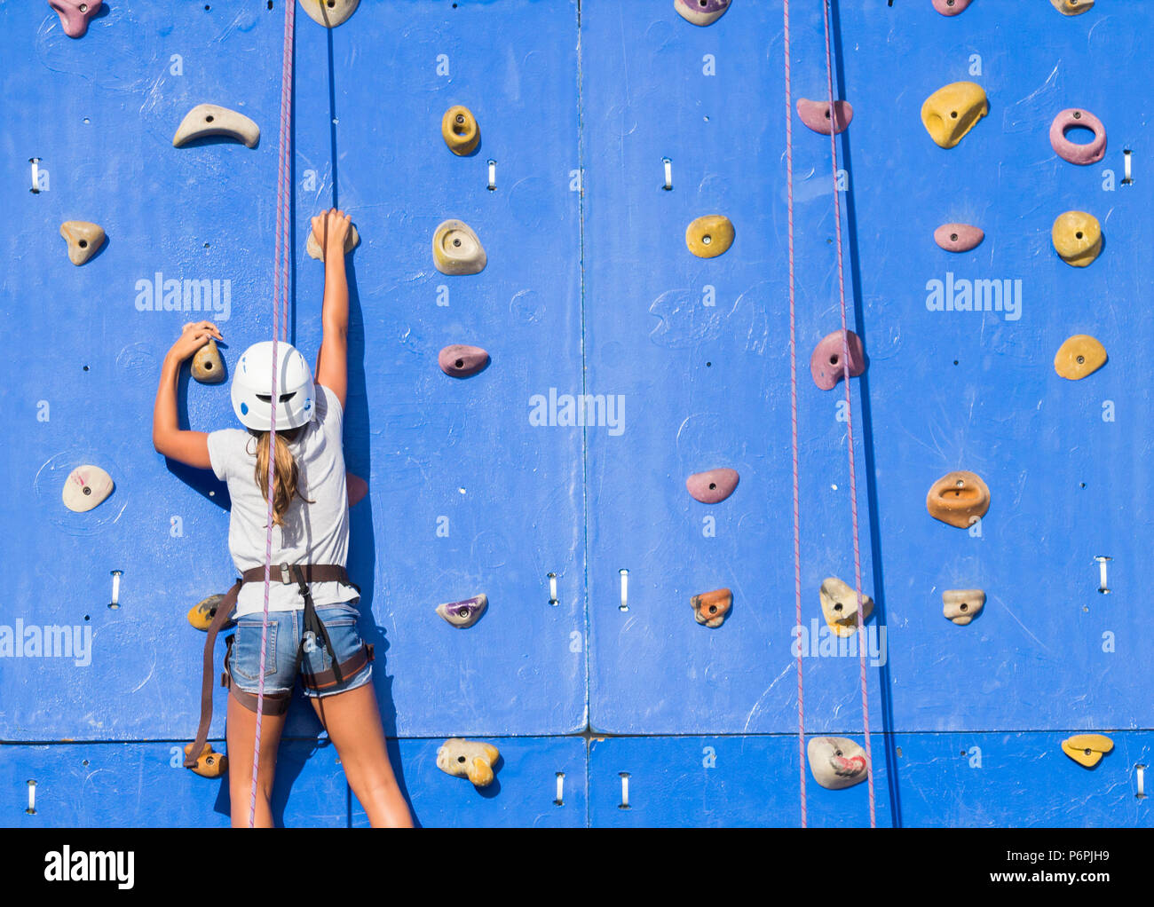 Young girls on outdoor climbing wall Stock Photo - Alamy