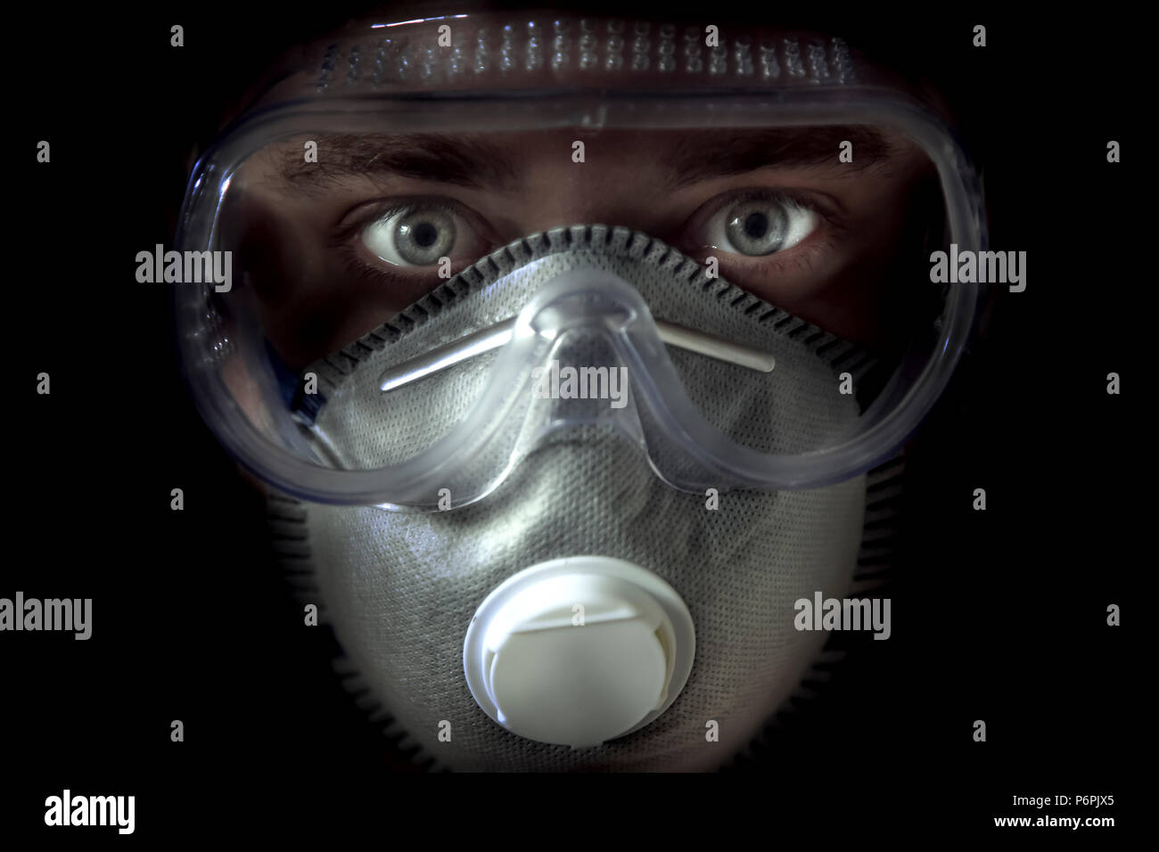 builder wearing a mask and glasses portrait on a black background Stock ...