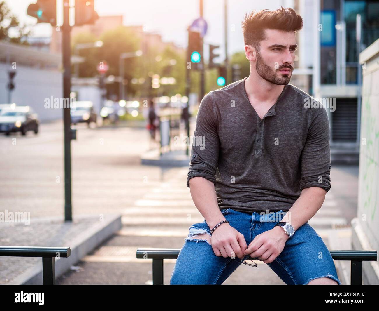 Attractive young man portrait in city street Stock Photo - Alamy