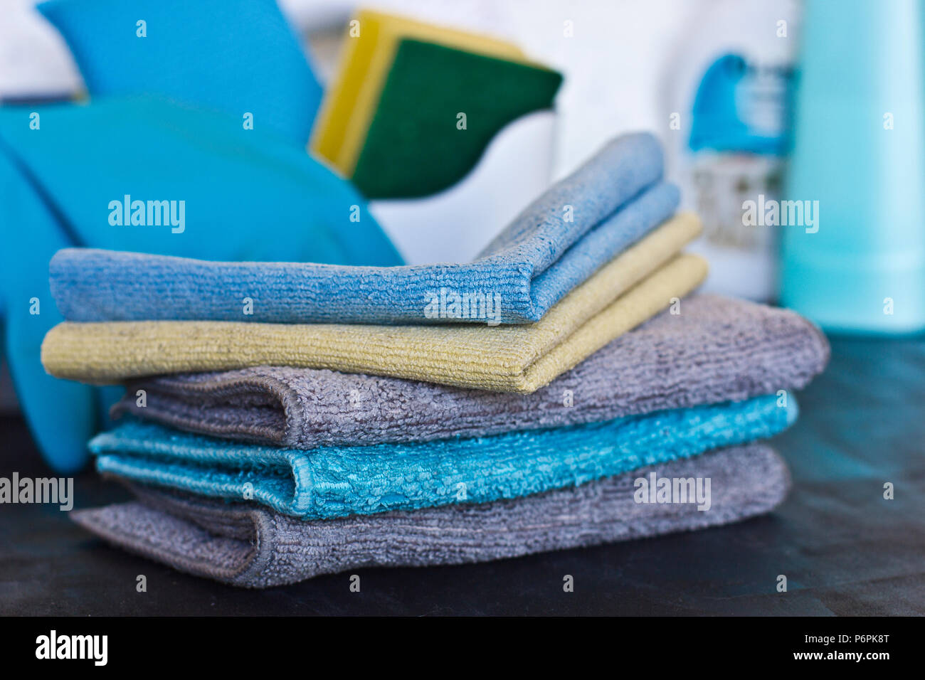 Cleaning stuff. Blue and grey microfiber napkins on the black ground ...