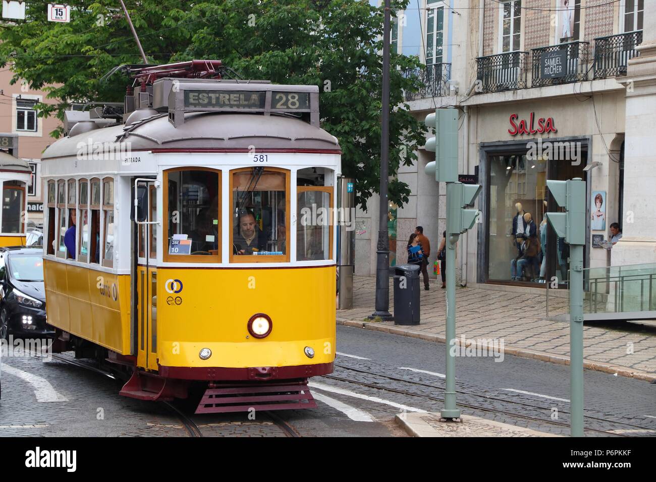 LISBON, PORTUGAL - JUNE 6, 2018: People ride the yellow tram Line 28 in ...